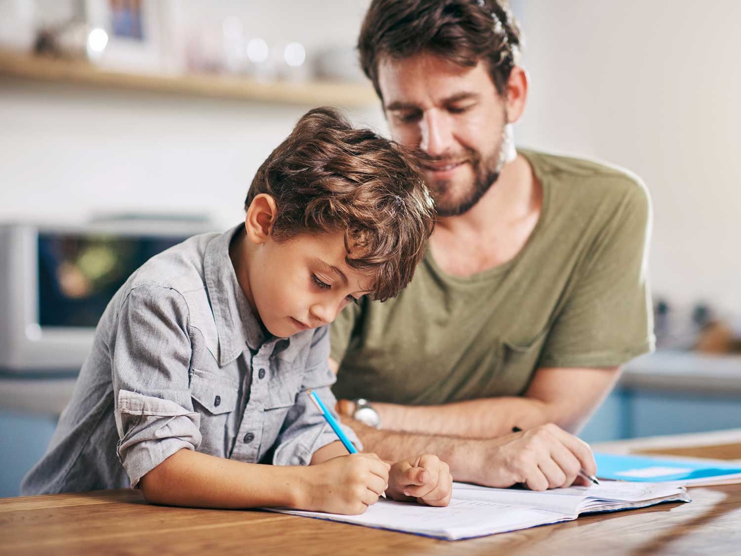 Child Doing Homework With Parent