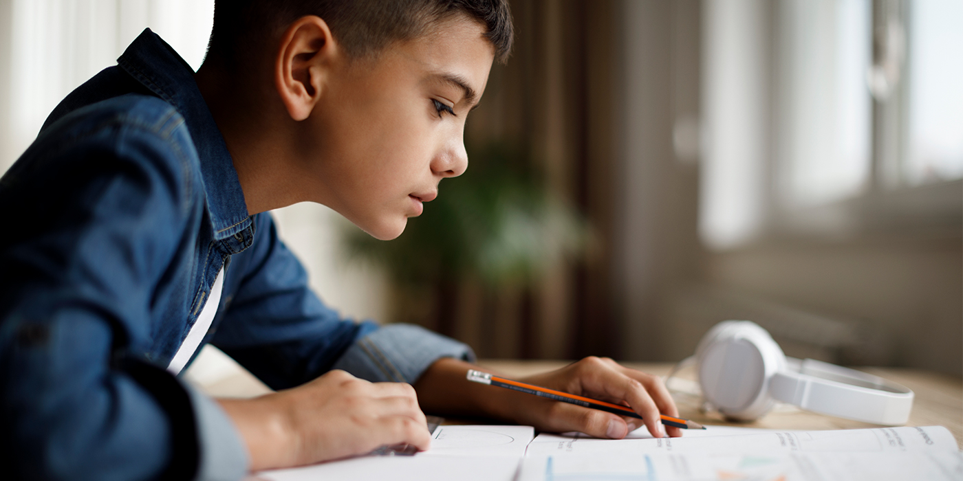 Boy Writing Ways To Help Your Child With ADHD Succeed At School